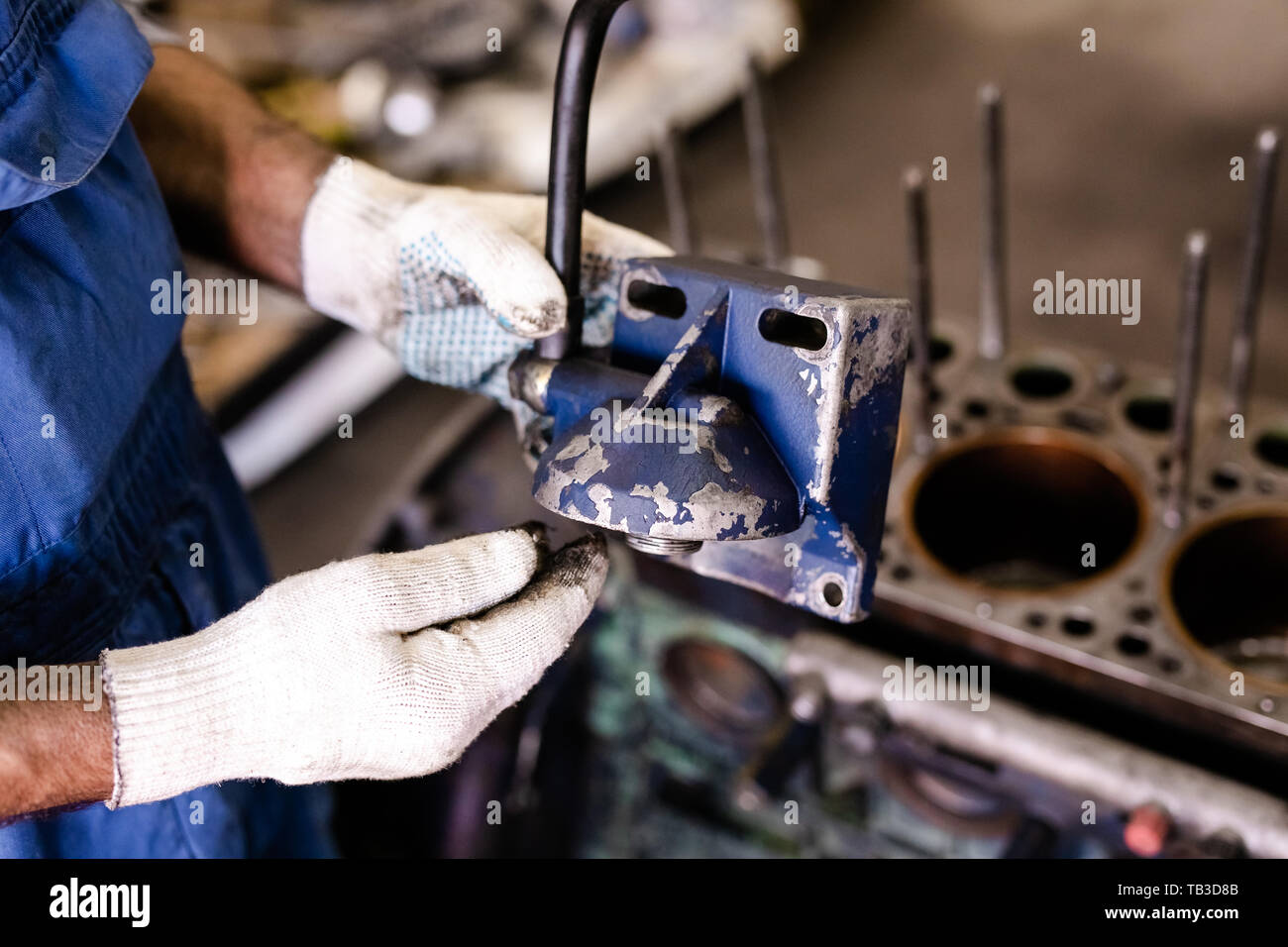 Mechanic repairs old motor of truck in a car repair station ...