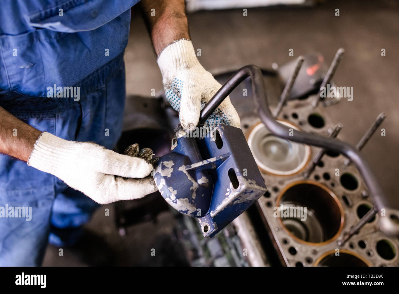 Mechanic repairs old motor of truck in a car repair station ...