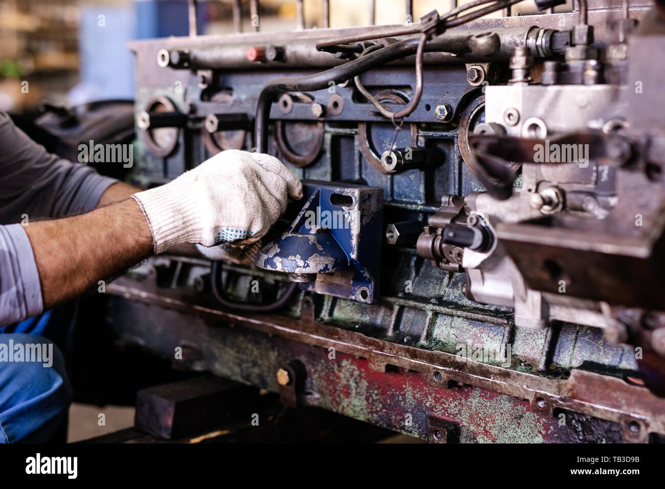Mechanic repairs old motor of truck in a car repair station ...