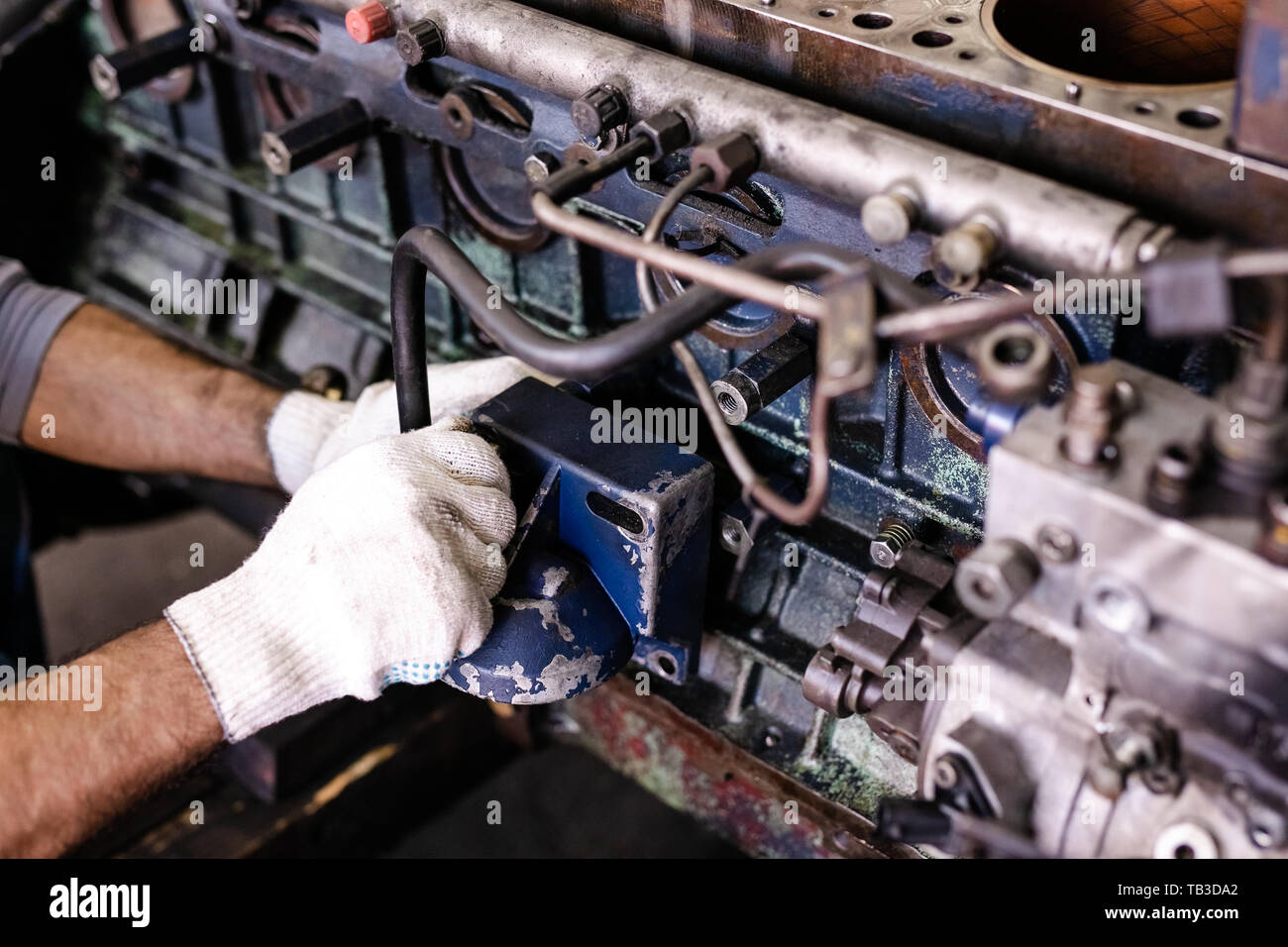Mechanic repairs old motor of truck in a car repair station ...