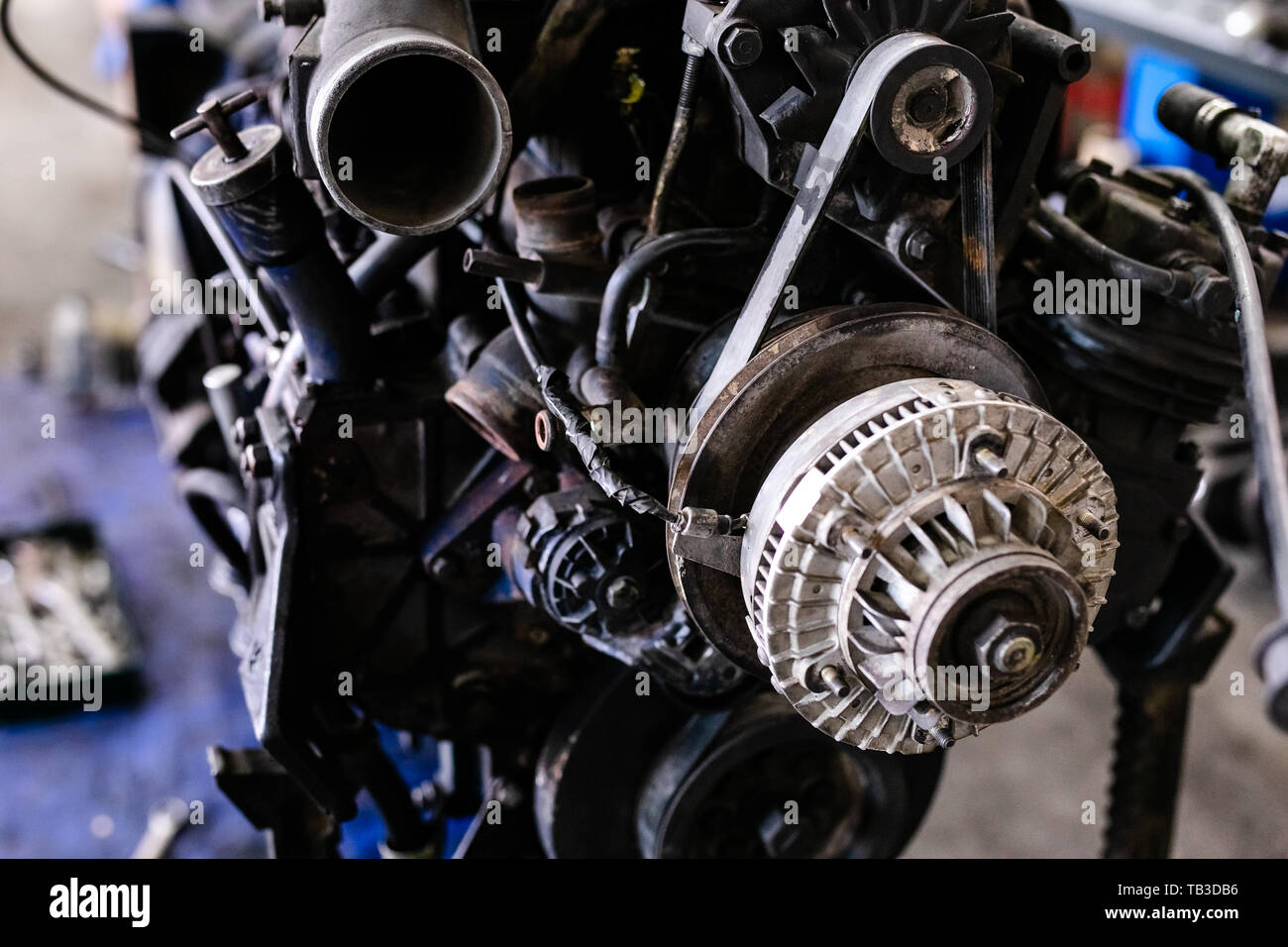 Mechanic repairs old motor of truck in a car repair station ...