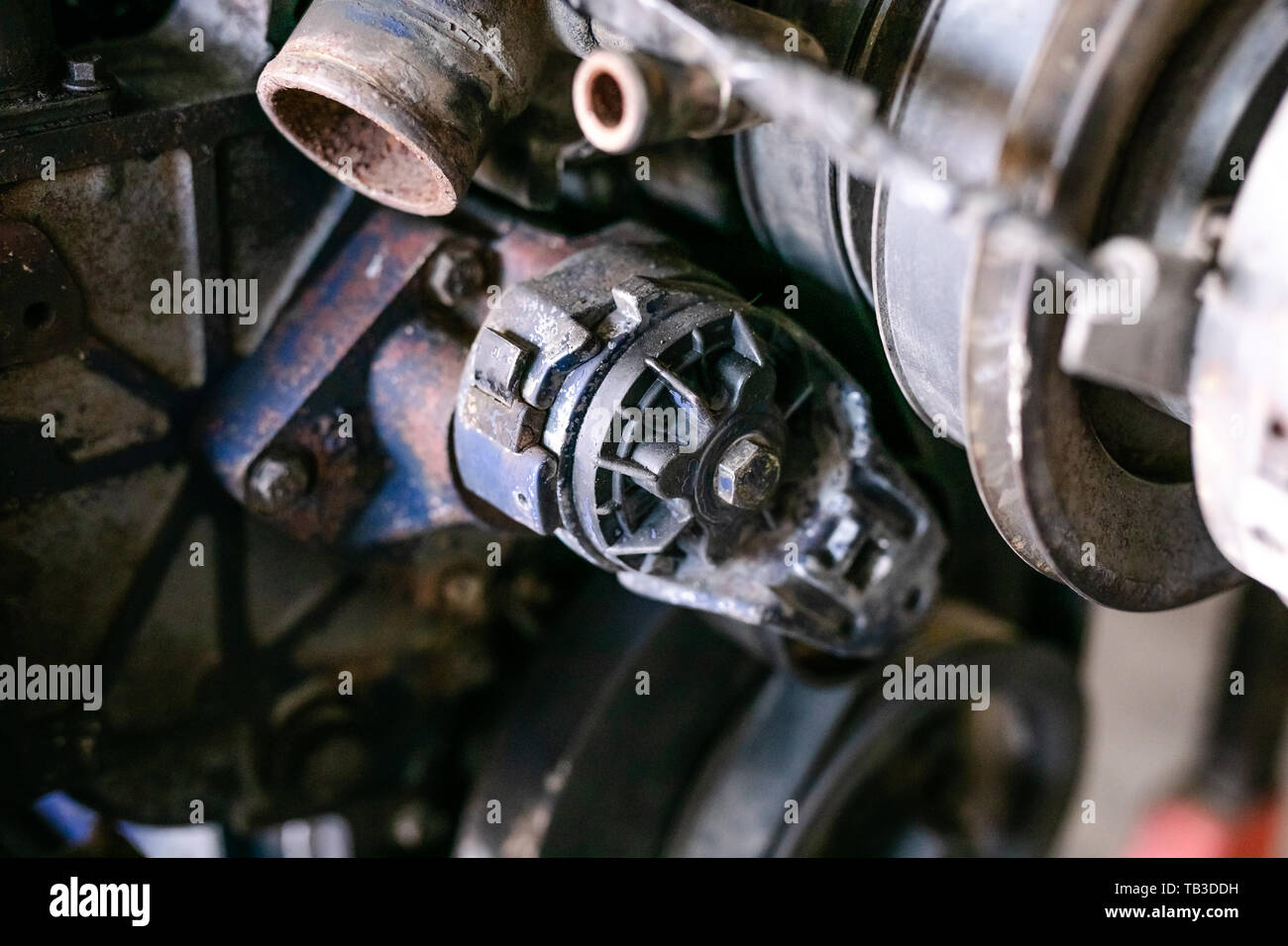 Mechanic repairs old motor of truck in a car repair station ...