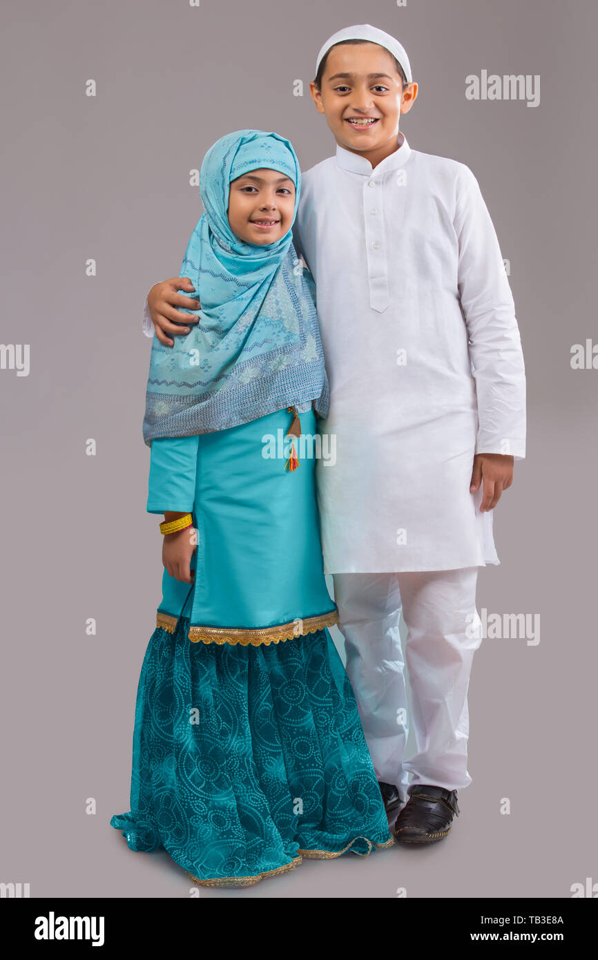 Young Muslim girl and boy holding each other and smiling Stock Photo ...