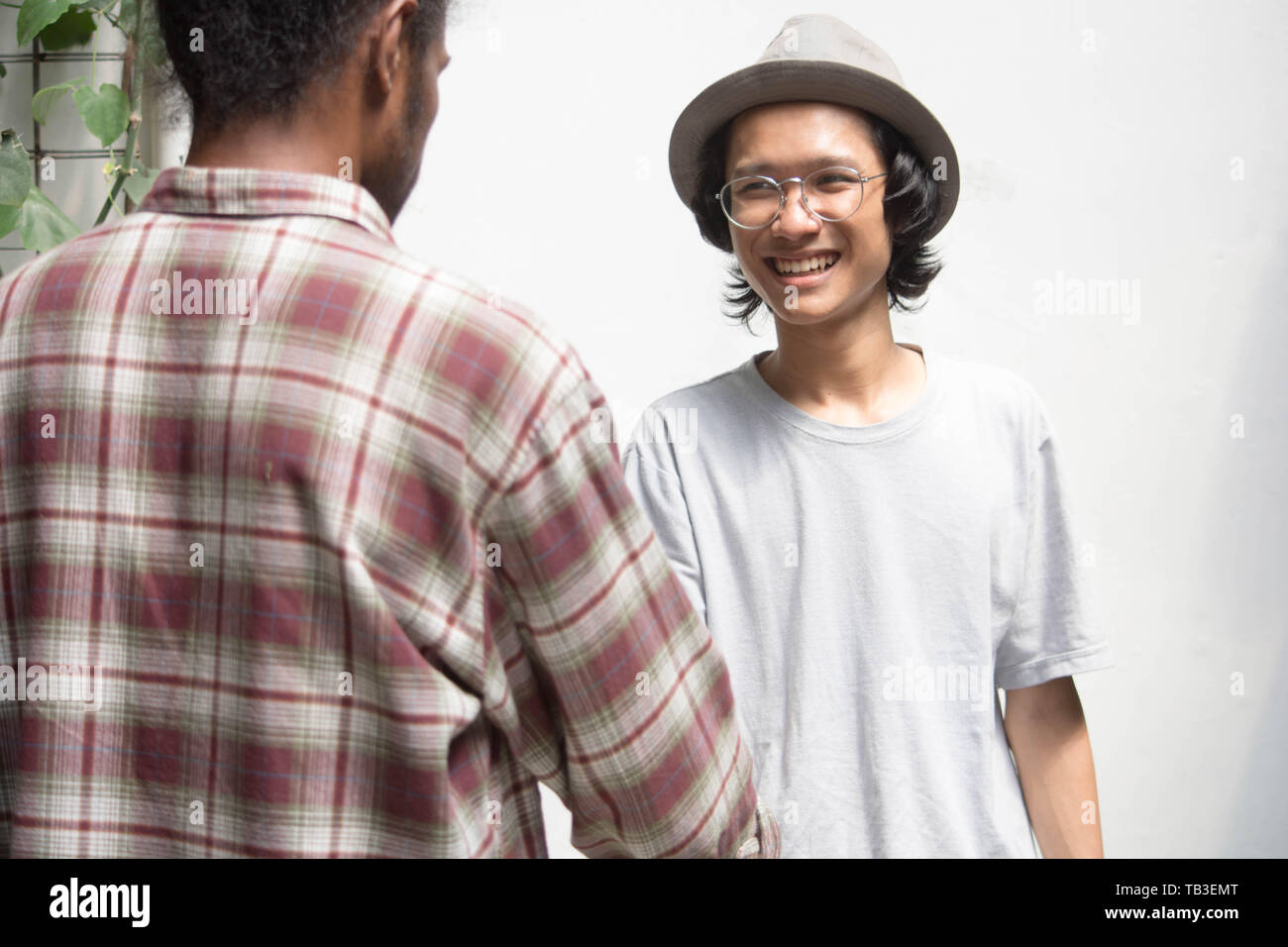 young asian male hand shake with friend as foreground, young asian man ...