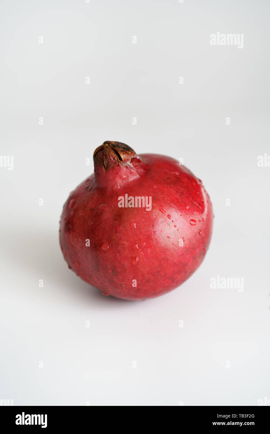 Organic whole pomegranate. White background, high resolution Stock ...
