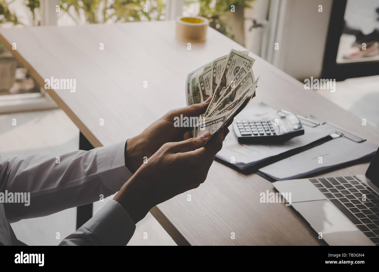 Business man counting dollar bill money in office Stock Photo - Alamy