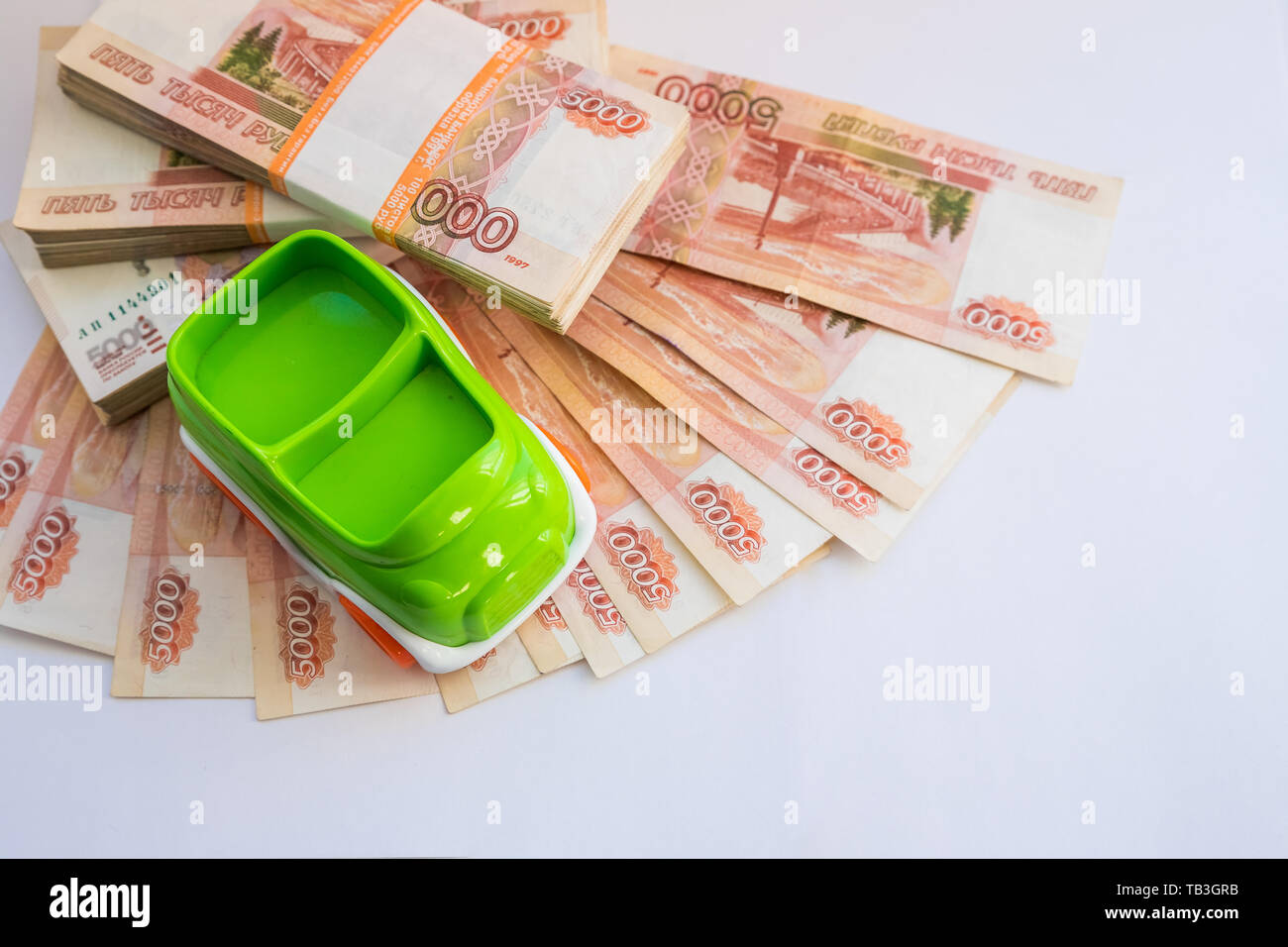 Miniature car model and Financial statement with paper money, paper ...