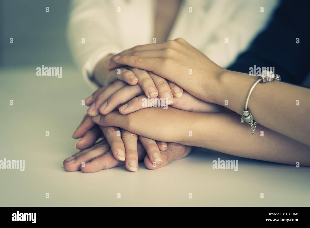 Team hand together in business meeting for team concept Stock Photo - Alamy