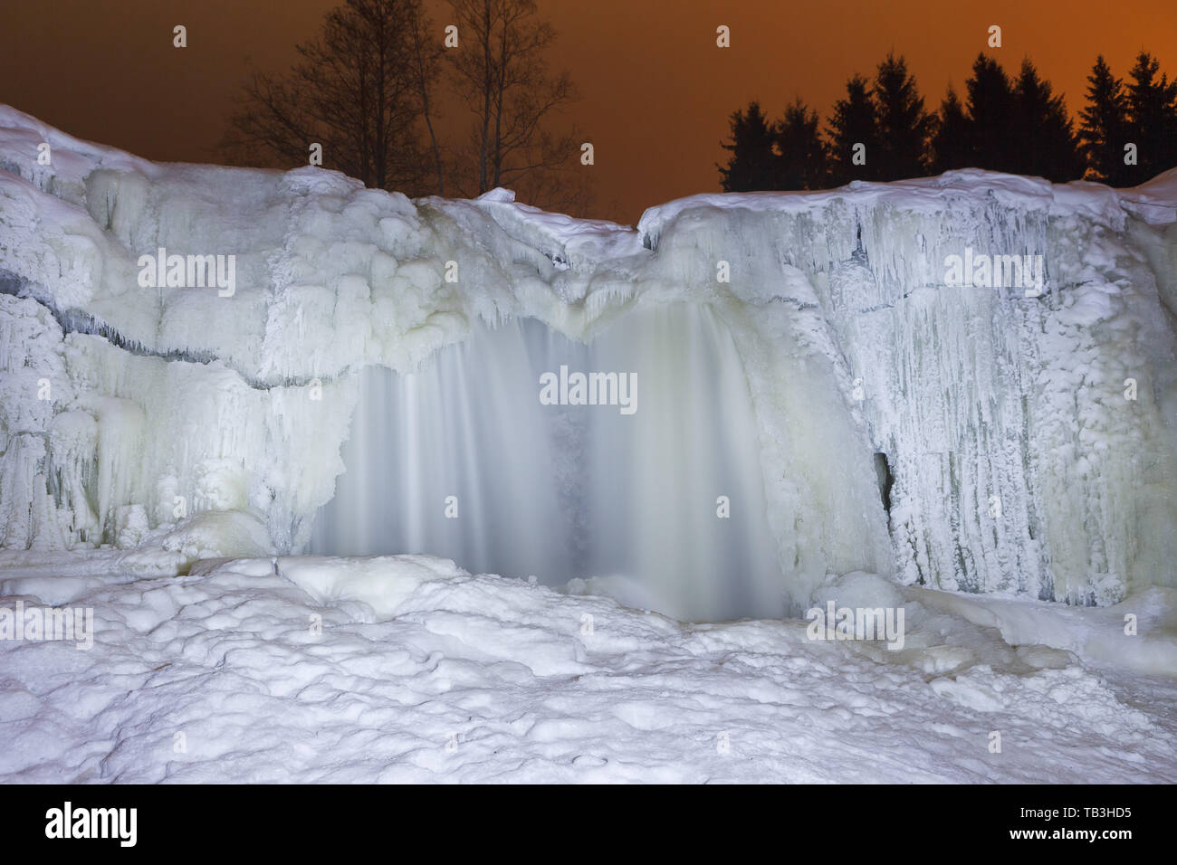 Frozen waterfall at night. Light painting illumination Stock Photo - Alamy
