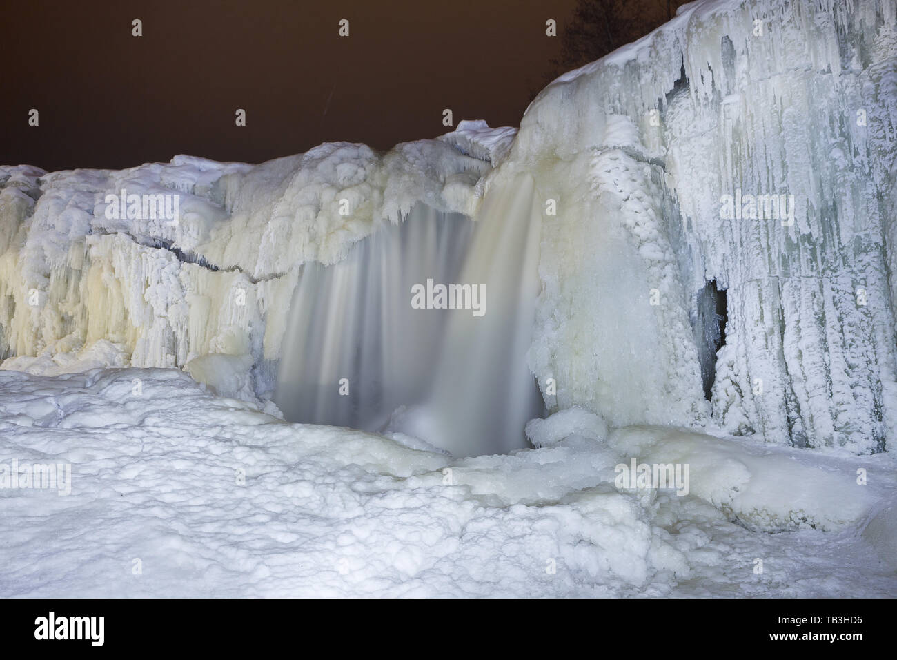 Frozen waterfall at night. Light painting illumination Stock Photo - Alamy