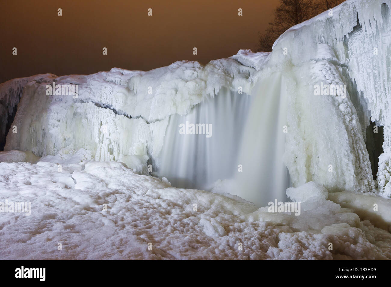 Frozen waterfall at night. Light painting illumination Stock Photo - Alamy