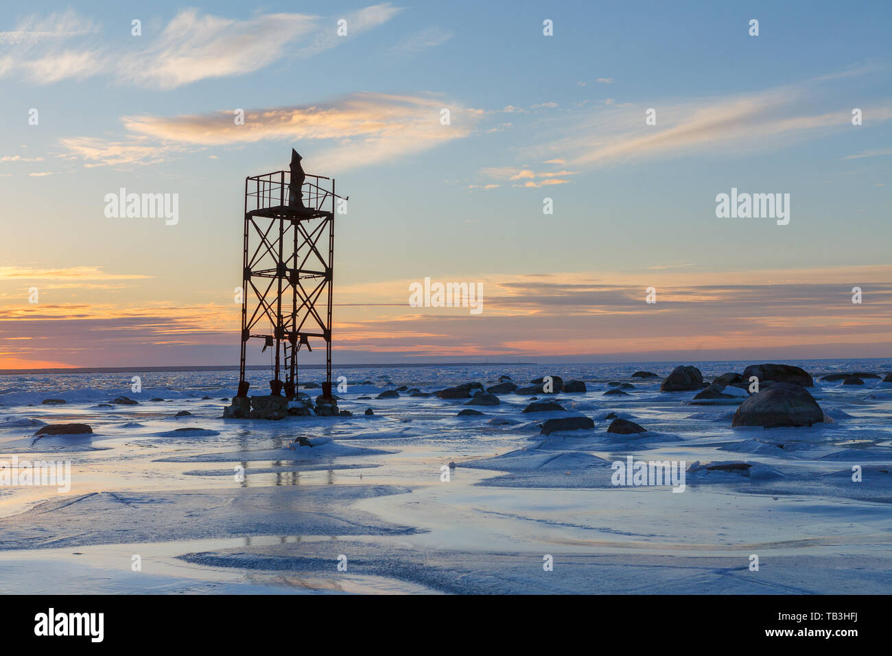 Monk on the abandoned military watching tower, orange sunset over ...