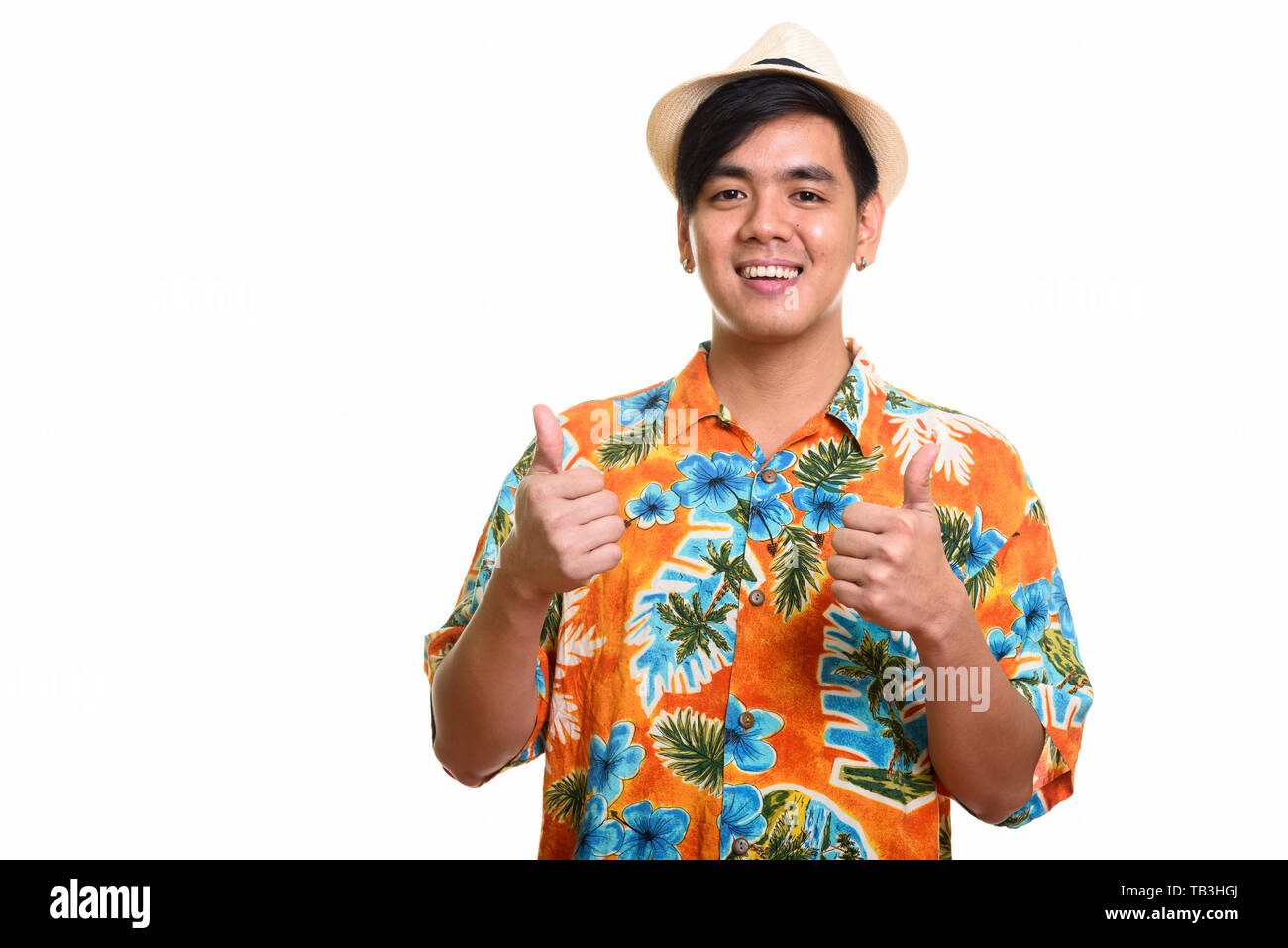 Young happy Asian man smiling and giving thumbs up Stock Photo - Alamy