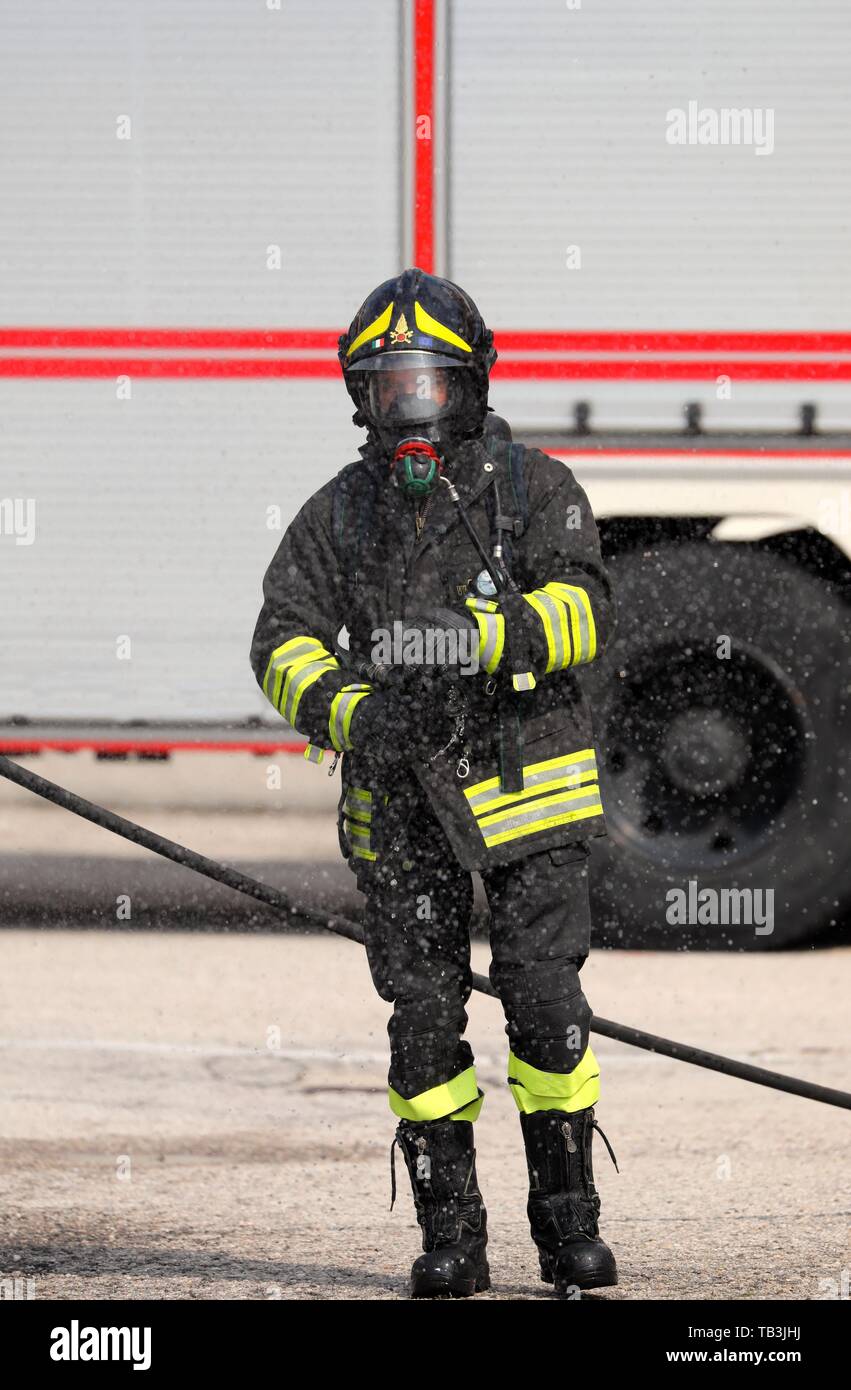 firefighter with helmet and uniform at fire department Stock Photo - Alamy