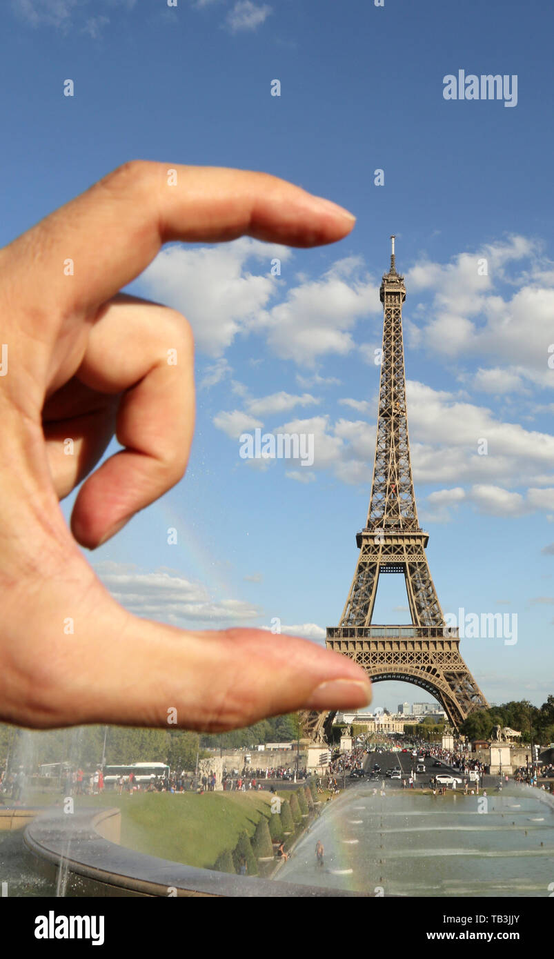 hand performing the measurement of the Eiffel Tower in Paris in France ...