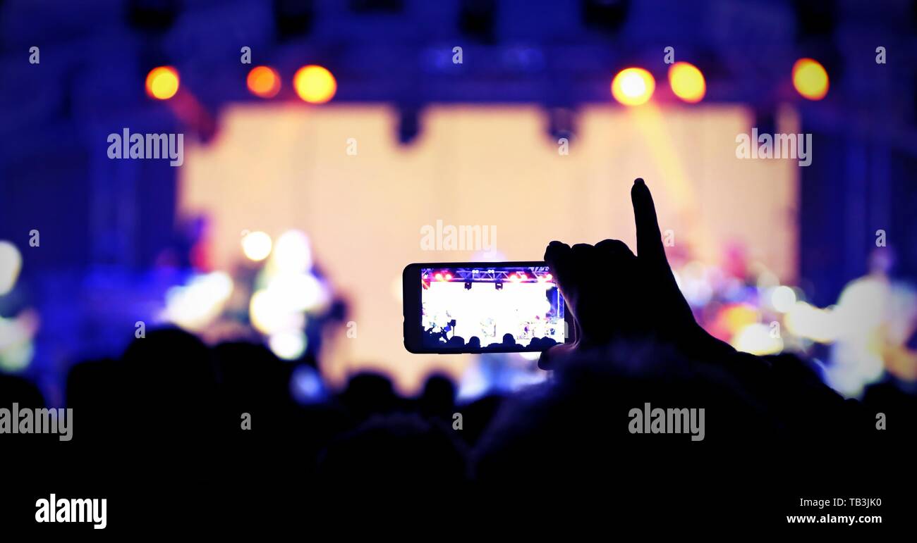crowd of people films the live concert with the smartphone Stock Photo ...