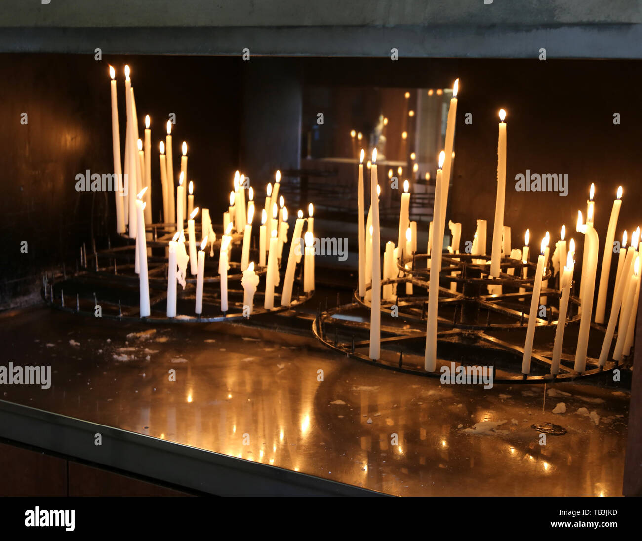 many votive candles lit by the faithful in church as religious ...
