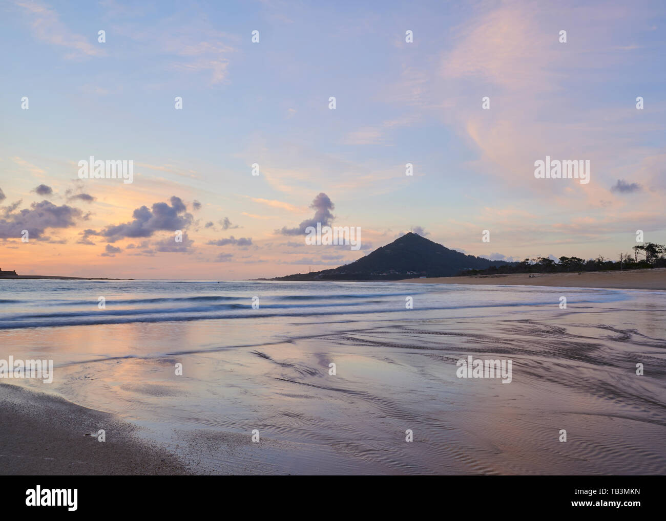 Beach of moledo at the end of the day, with a view to trega mountain on ...