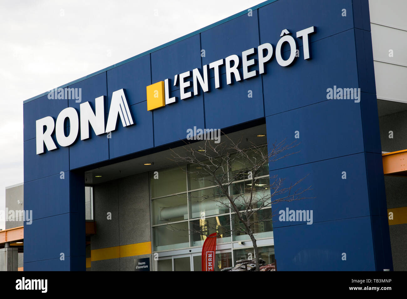 A logo sign outside of a Rona, Inc., retail store location in Brossard ...