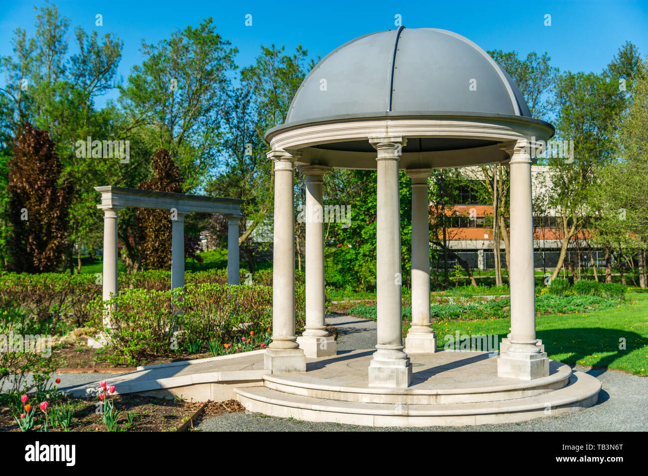Garden featuring Arch with columns Stock Photo - Alamy