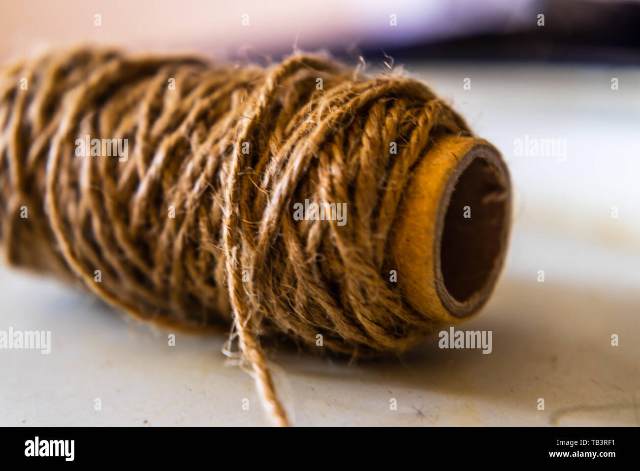 Jute string roll close up on blurred white background Stock Photo - Alamy