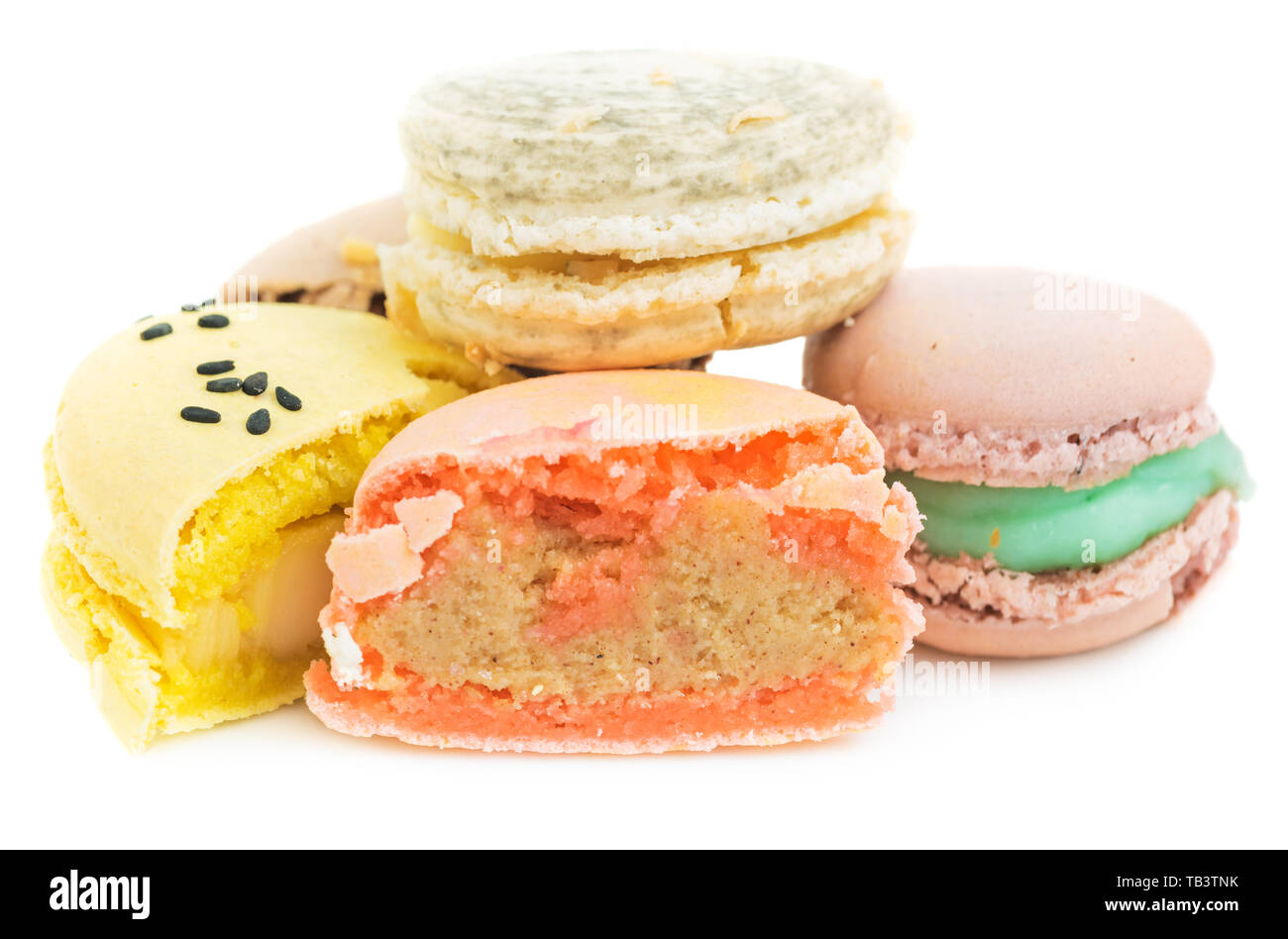 Pile of different types of french sweet cookies, macaroons cut in half ...