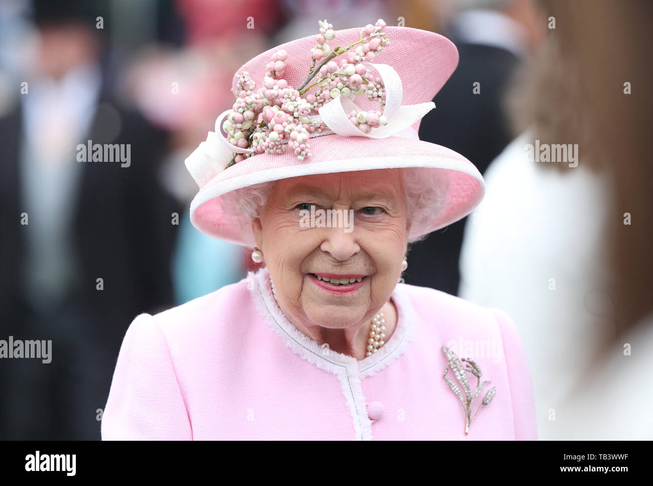Queen Elizabeth II meets guests during a Royal Garden Party at ...