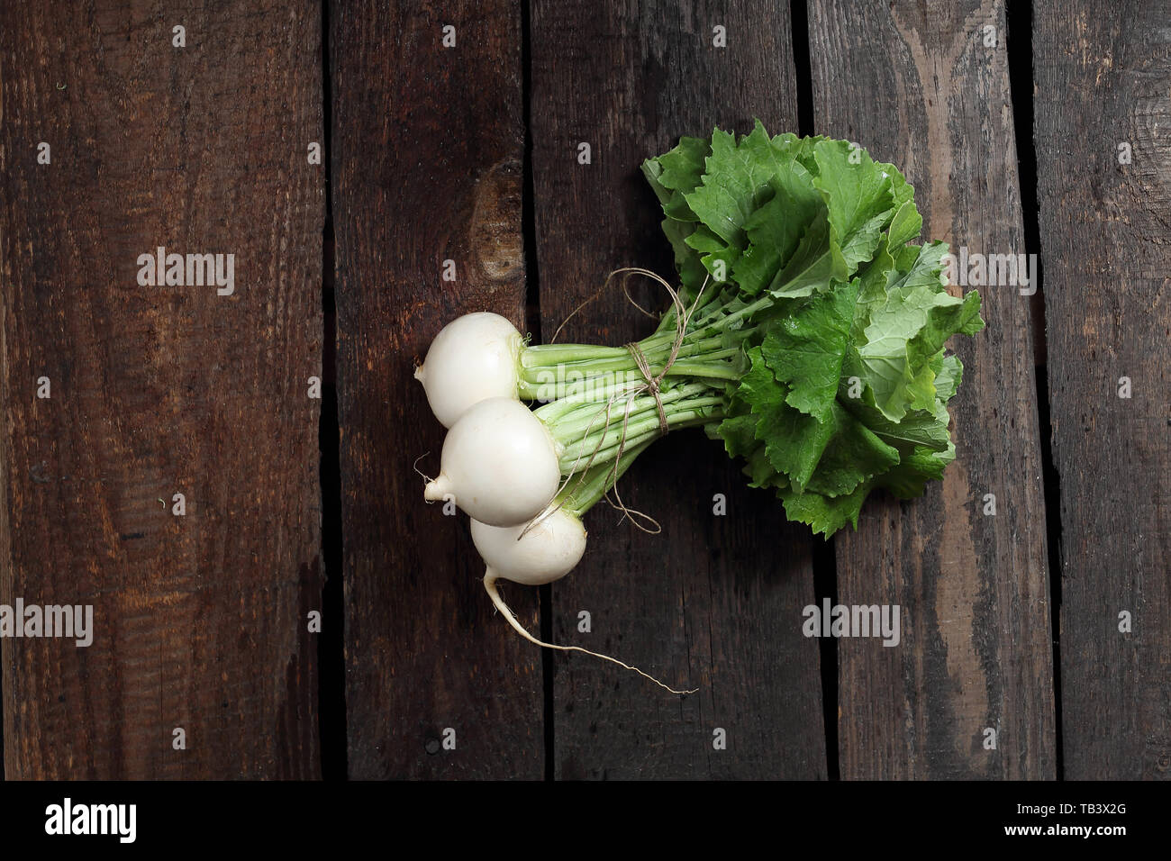 White radish. Young round radish on a wooden background Stock Photo - Alamy
