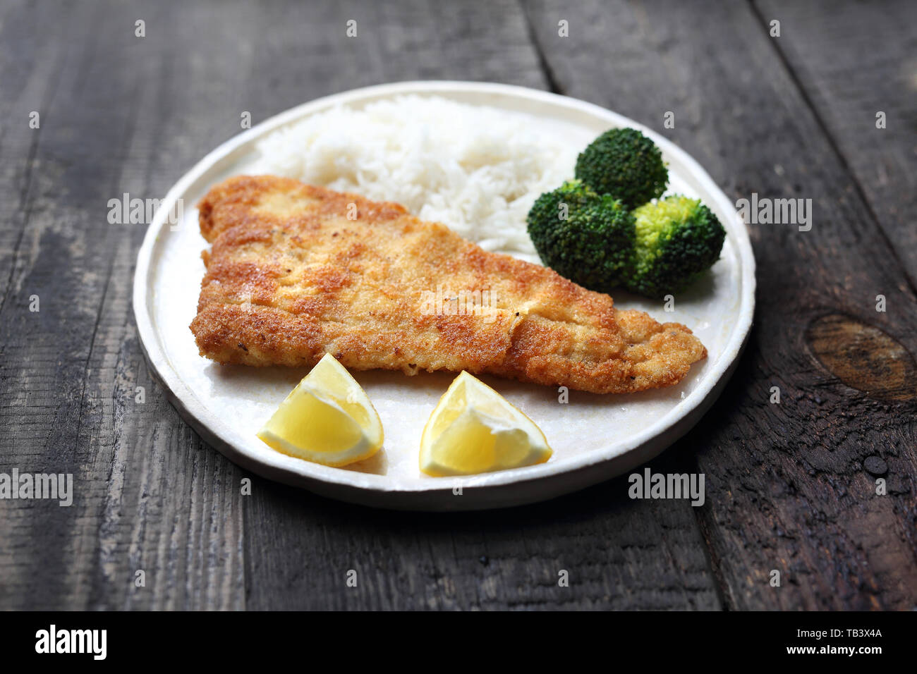 Cod fillet fried with rice and broccoli Stock Photo - Alamy