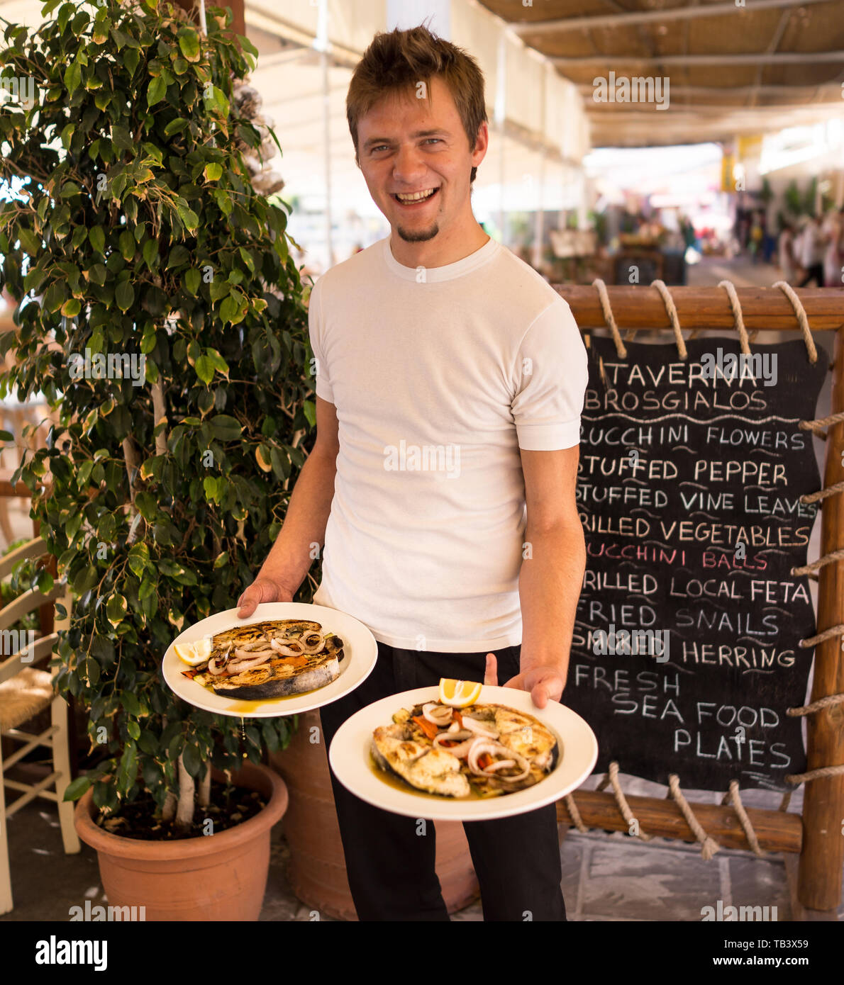 Greek waiter plates hi-res stock photography and images - Alamy