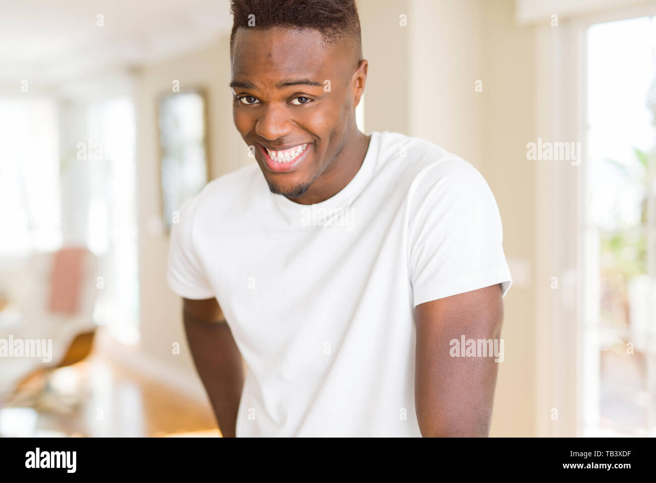Handsome african young man smiling cheerful with a big smile on face ...
