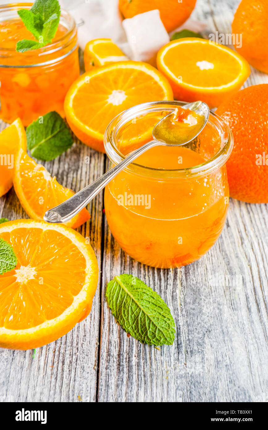 Homemade orange jam, with fresh sliced oranges and mint leaves, white ...