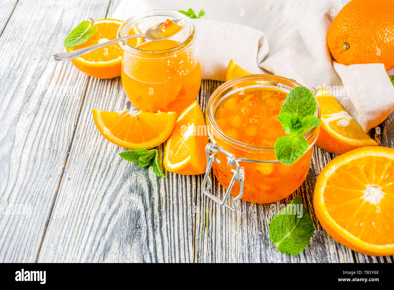 Homemade orange jam, with fresh sliced oranges and mint leaves, white ...