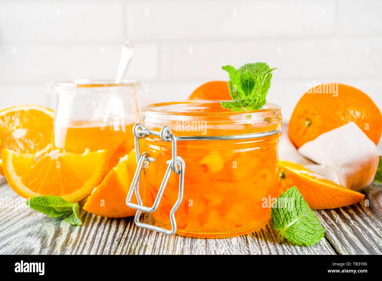 Homemade orange jam, with fresh sliced oranges and mint leaves, white ...