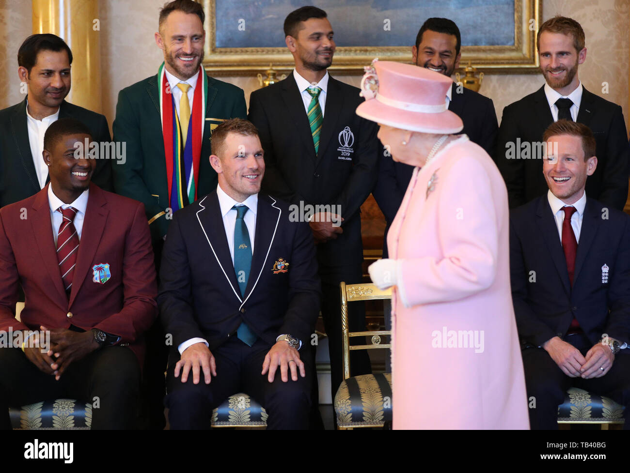 Queen Elizabeth II joins the captains of the teams taking part in the ...