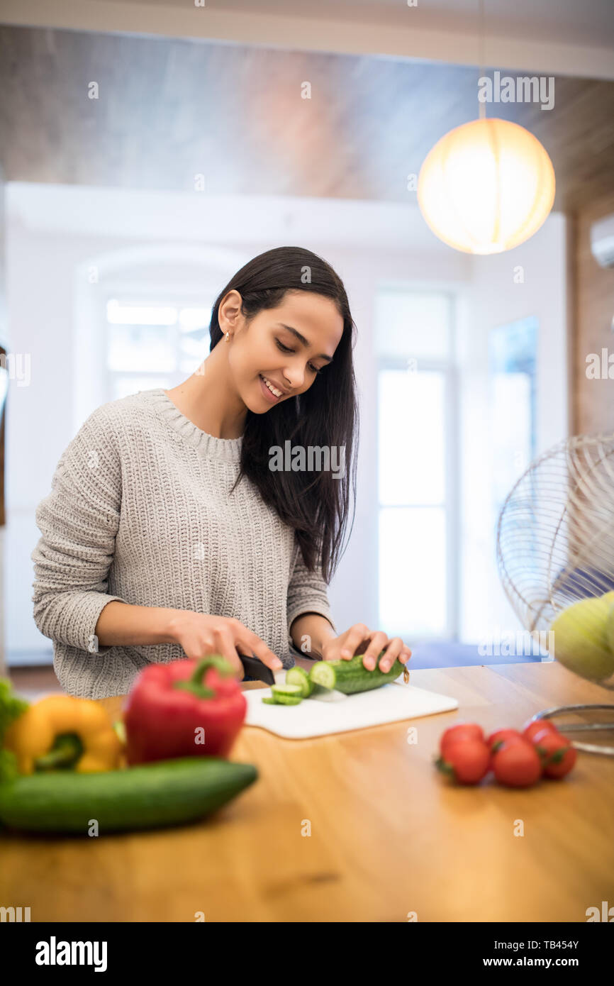Beautiful woman cooking healthy food in the kitchen - indoors Stock ...