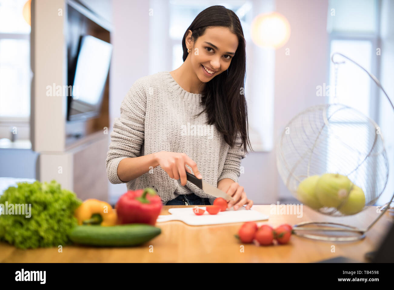 Beautiful woman cooking healthy food in the kitchen - indoors Stock ...