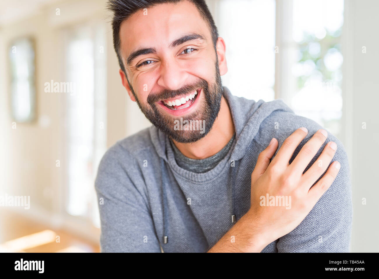 Handsome man smiling cheerful with a big smile on face showing teeth ...