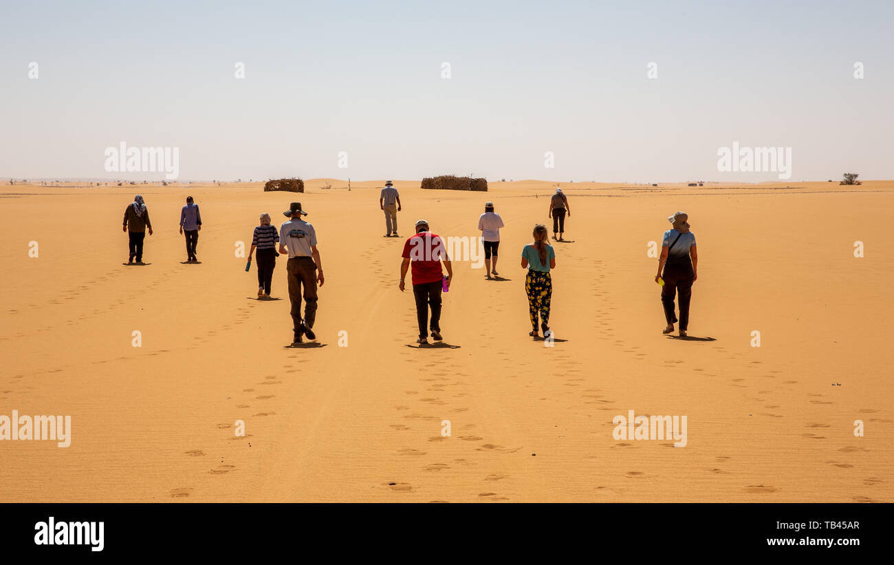 tourists walk through sweltering heat in western desert of Sudan ...
