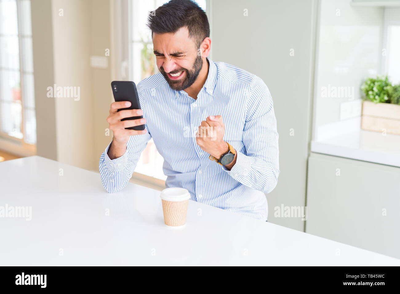 Handsome hispanic business man drinking coffee and using smartphone ... Handsome hispanic business man drinking coffee and using smartphone ...