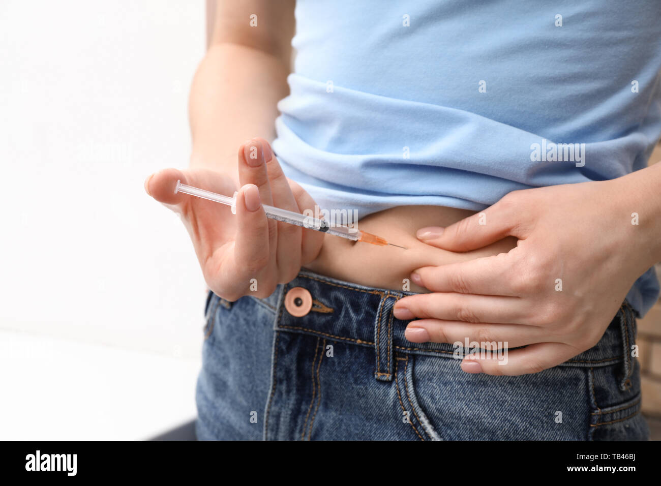 Diabetic woman giving herself insulin injection at home, closeup Stock ...