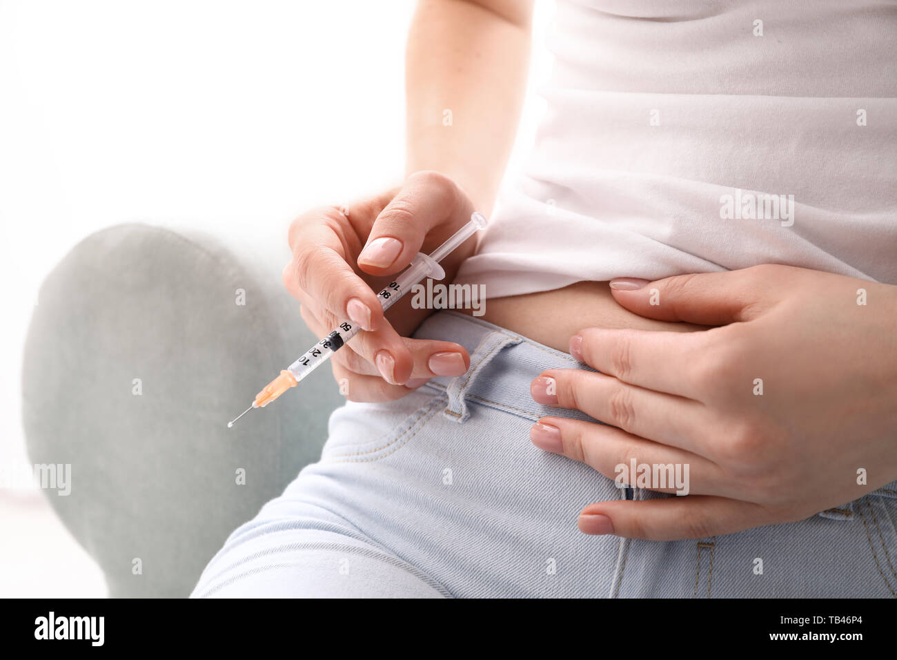 Diabetic woman giving herself insulin injection at home, closeup Stock ...