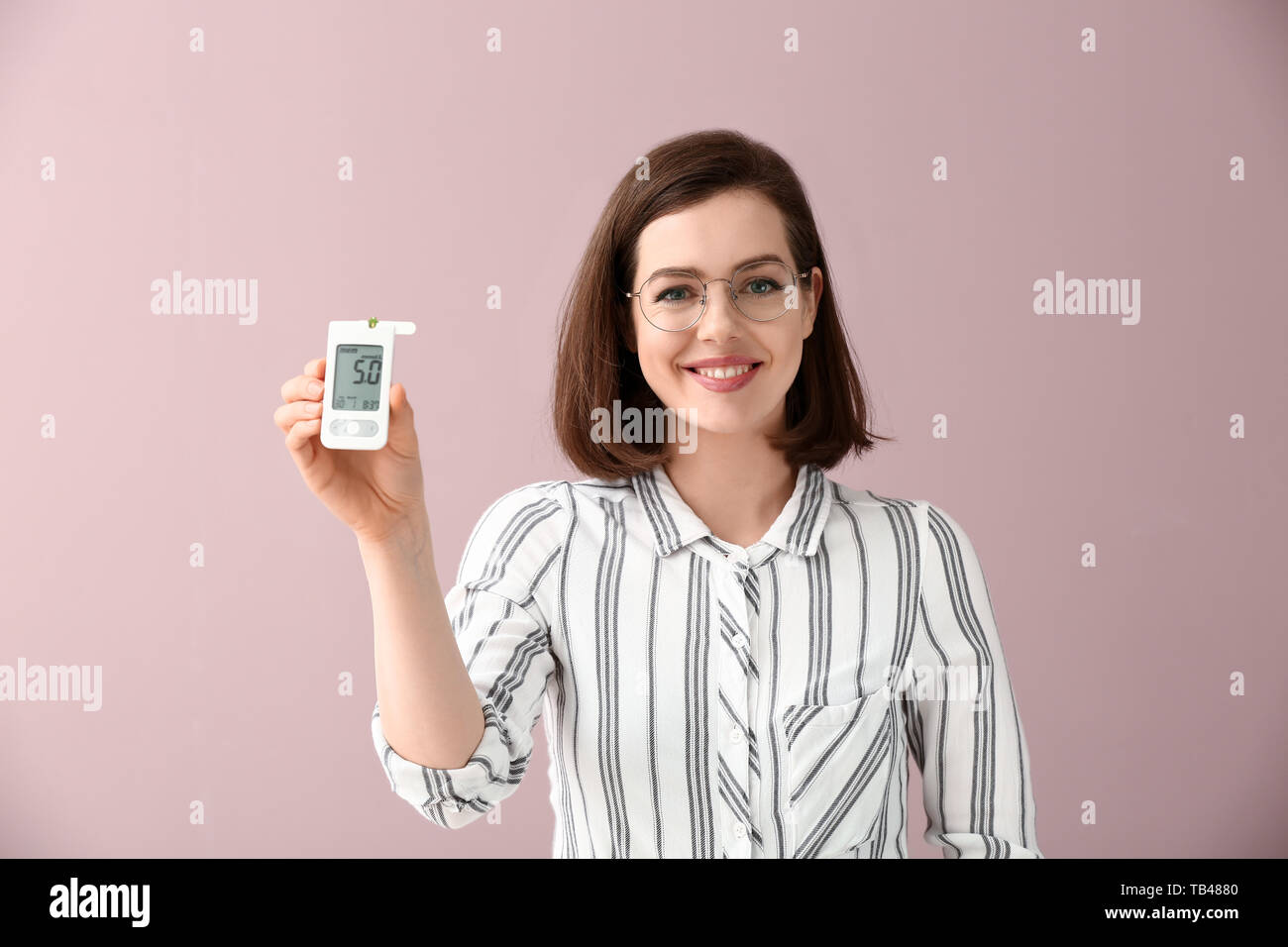 Woman taking diabetes test glucometer hi-res stock photography and ...