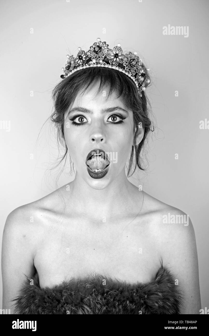 Emotional queen with surprised face and fashionable makeup in crown ...