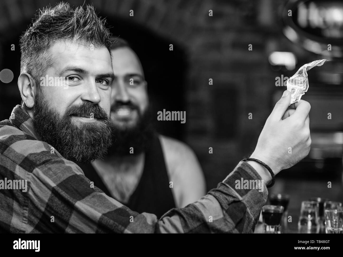 Hipster brutal bearded man spend leisure with friend at bar counter ...