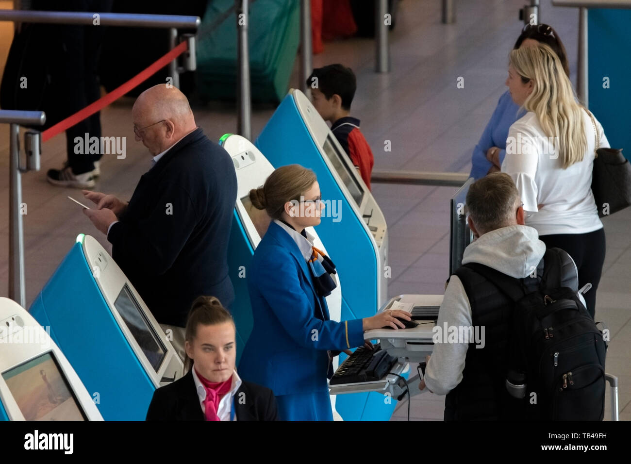 Ground Stewardess Helping People At The Gates Of Schiphol Airport The ...