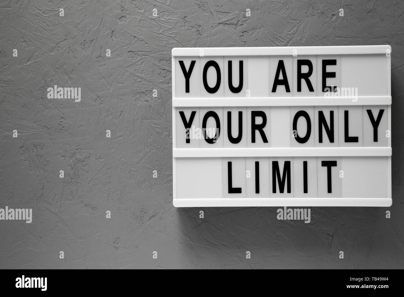 'You are your only limit' words on a modern board over gray surface ...