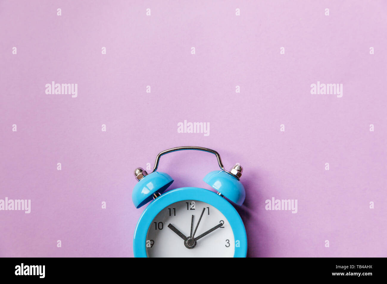 Ringing twin bell vintage classic alarm clock Isolated on purple violet ...