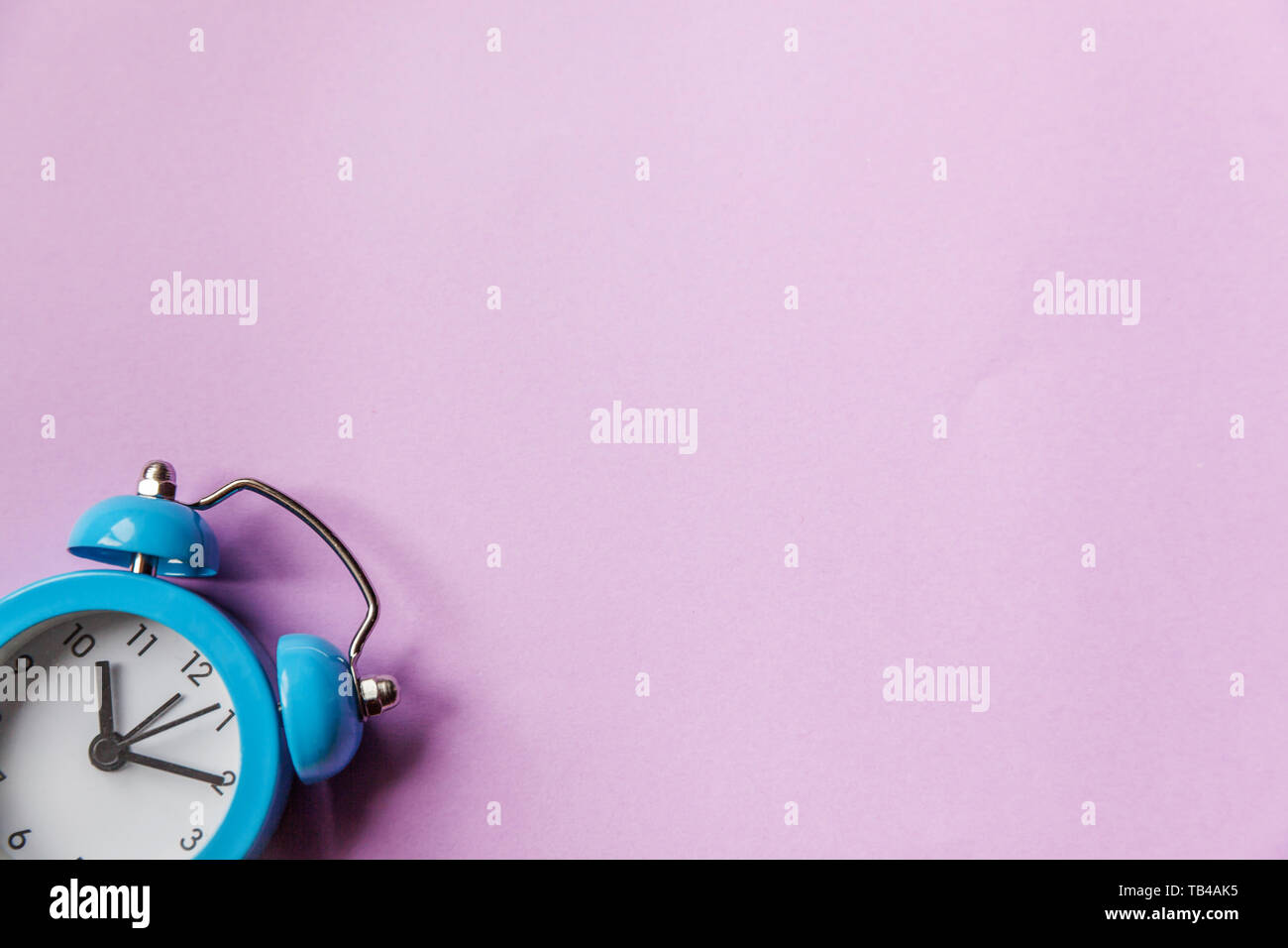 Ringing twin bell vintage classic alarm clock Isolated on purple violet ...