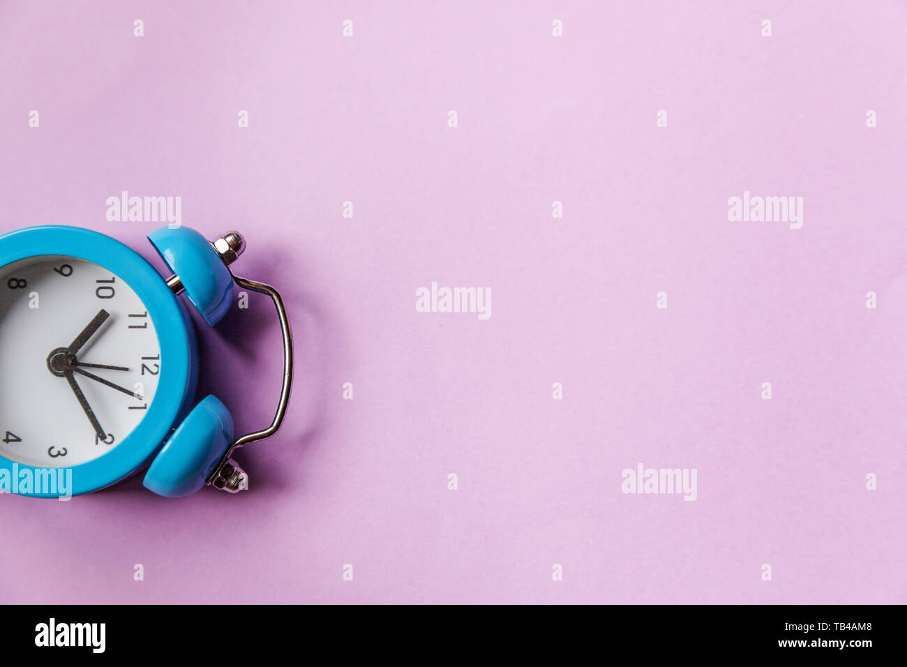 Ringing twin bell vintage classic alarm clock Isolated on purple violet ...